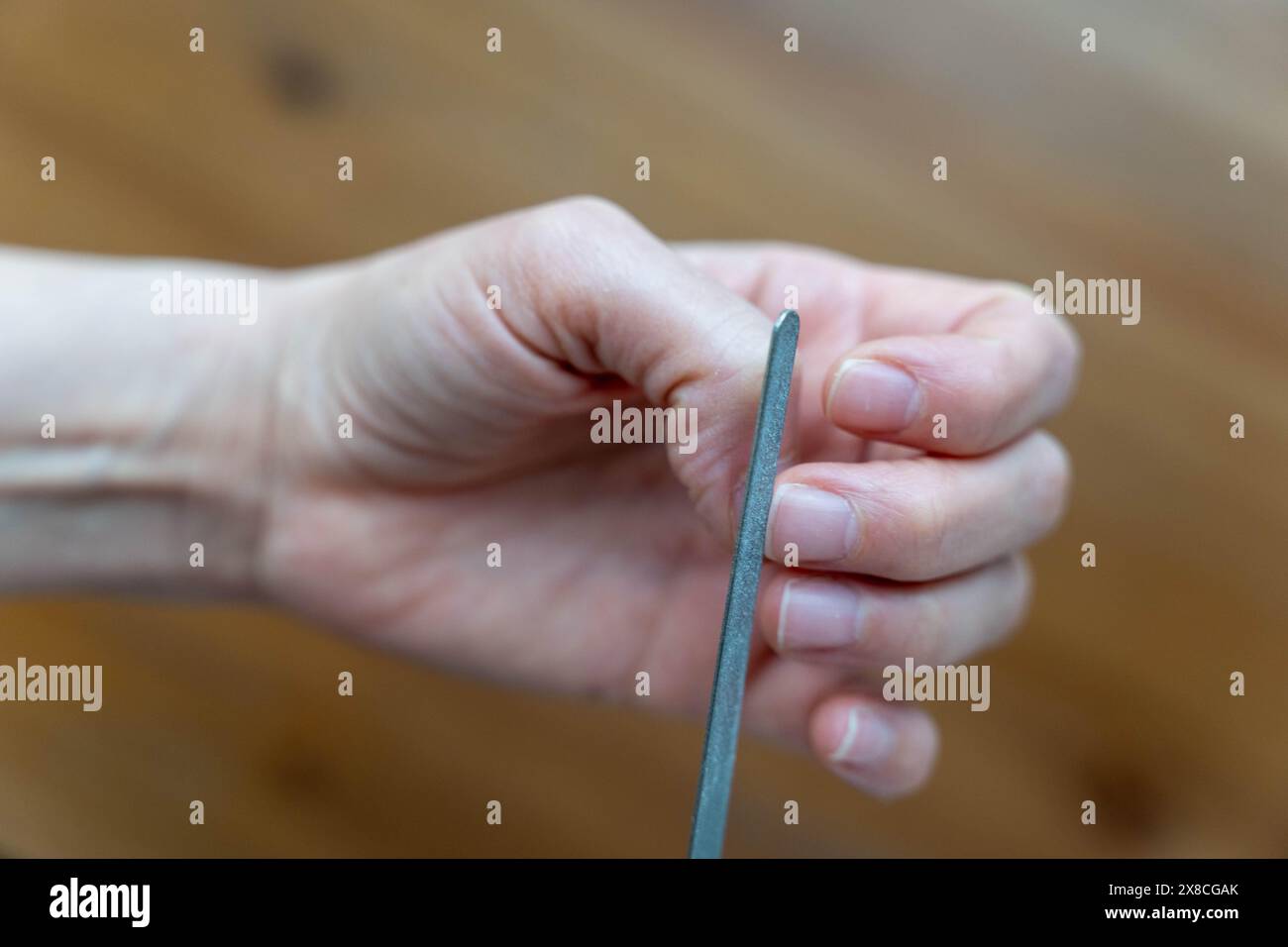 woman's hands undergoing a professional manicure treatment, focusing on ...