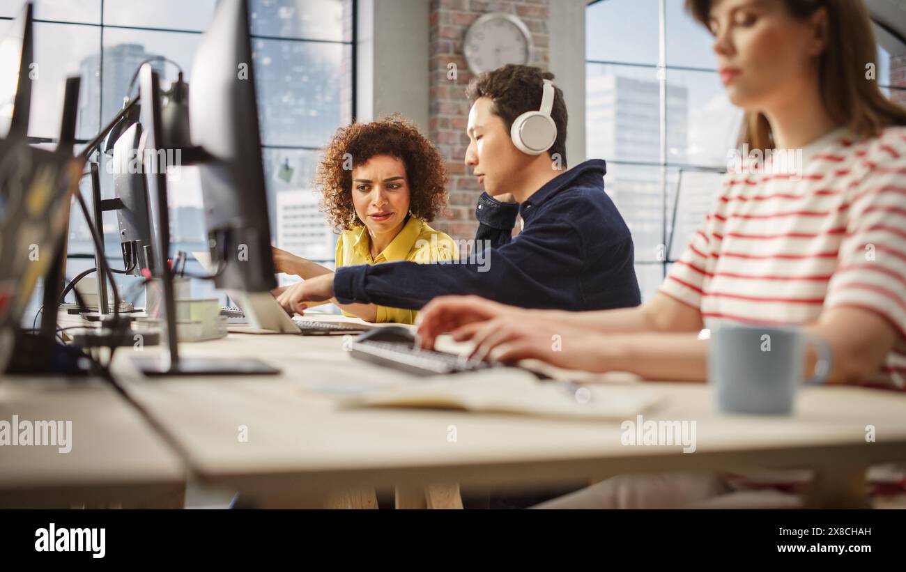 Group of Colleagues Working On Computers in Office. Female Biracial ...