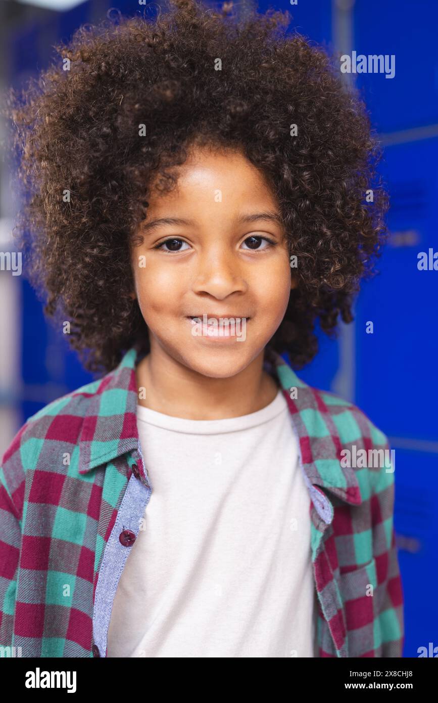In school, young biracial boy is standing, smiling Stock Photo - Alamy
