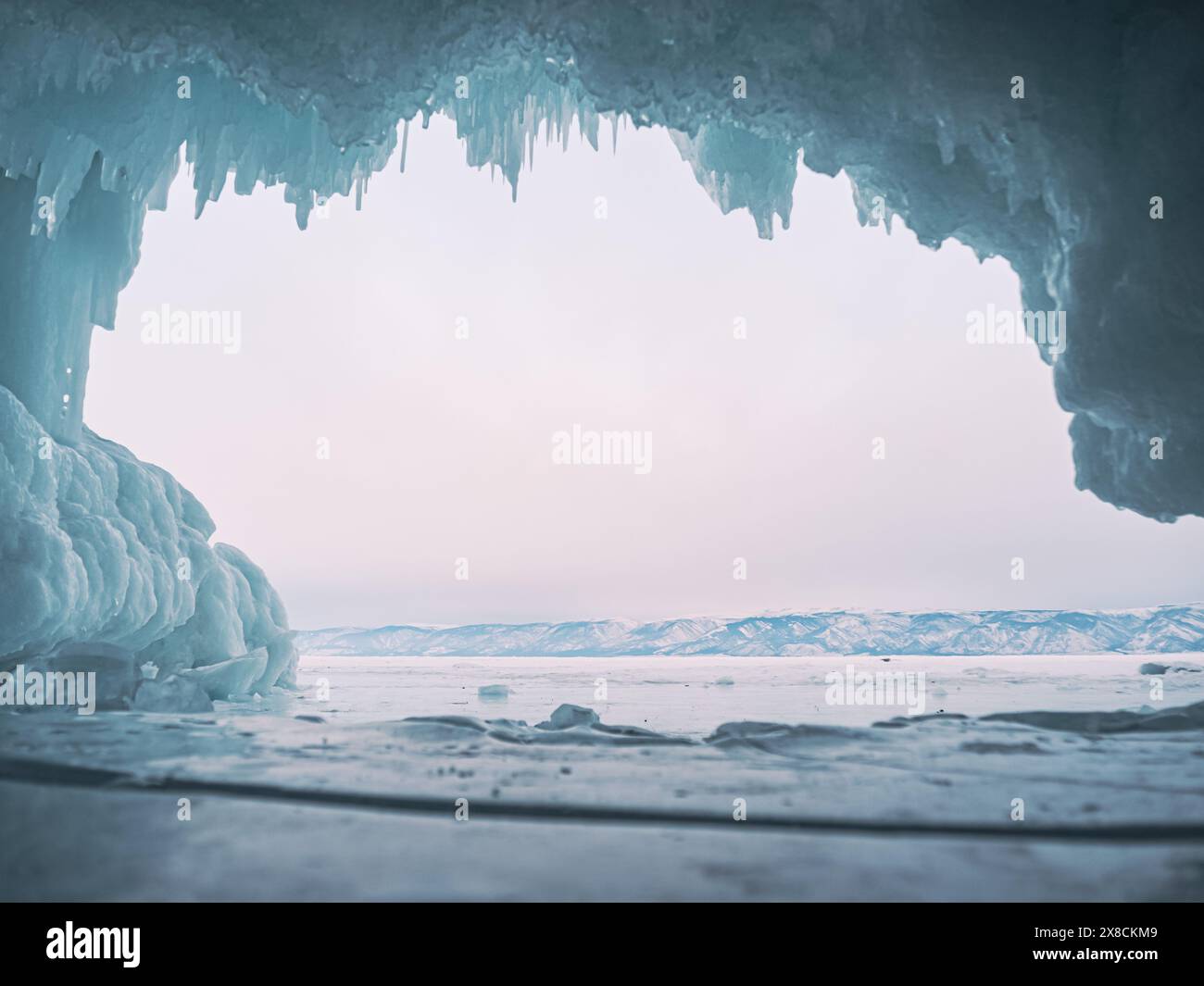 Inside a stunning ice cave on Lake Baikal, large icicles hang from the ...