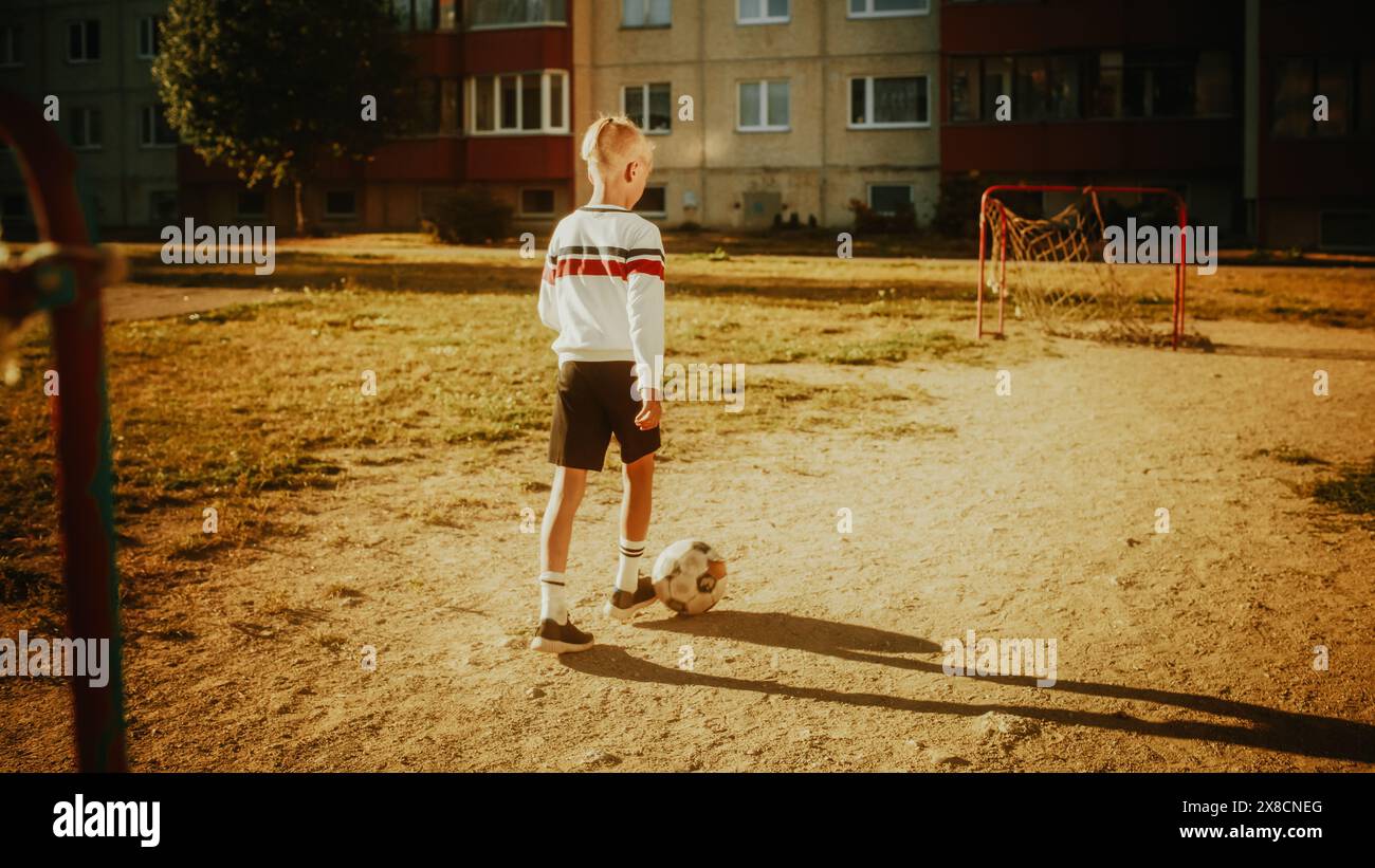 Sporty Caucasian Kid Playing with Ball in the Neighborhood. Young Boy ...
