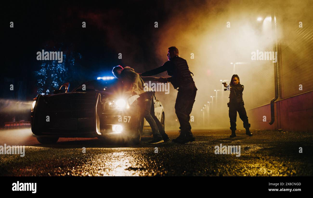 Male Policeman Forcing a Dangerous Criminal on the Hood of Police Car ...