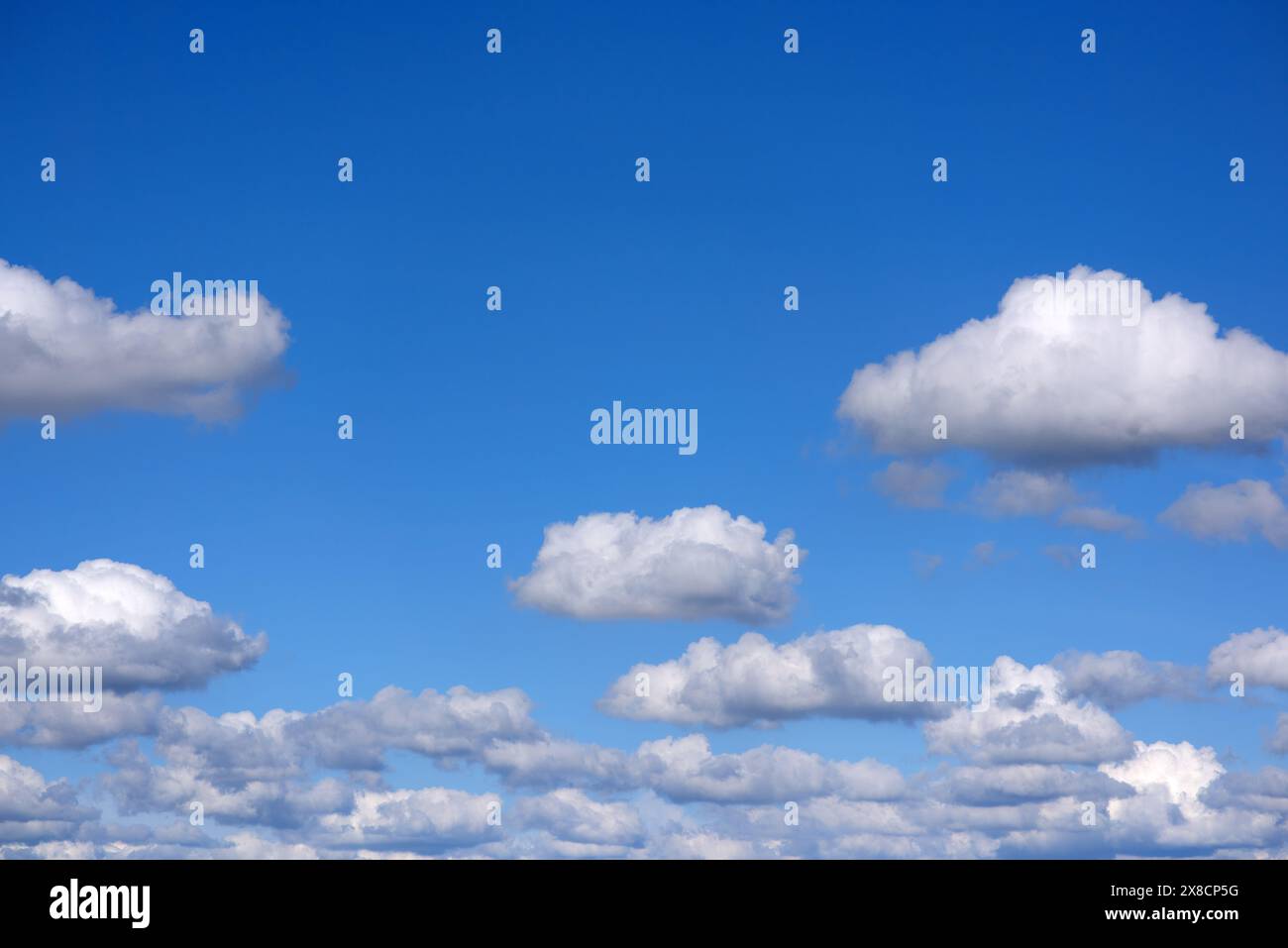 small soft cumulus fair weather clouds in a blue sky Stock Photo - Alamy