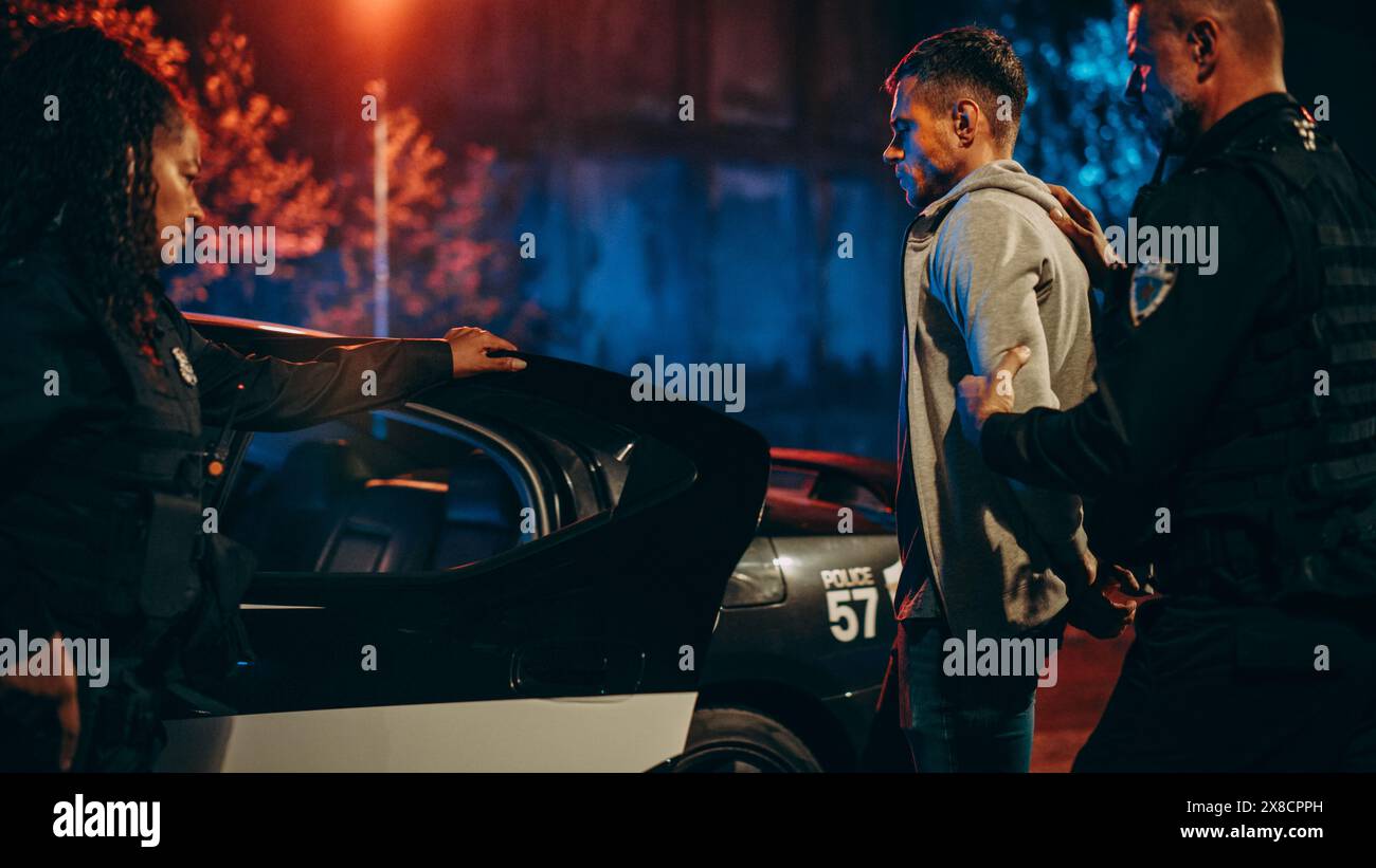 Two Police Officers Arrest Suspect, Put Him in Patrol Car. Officers of ...