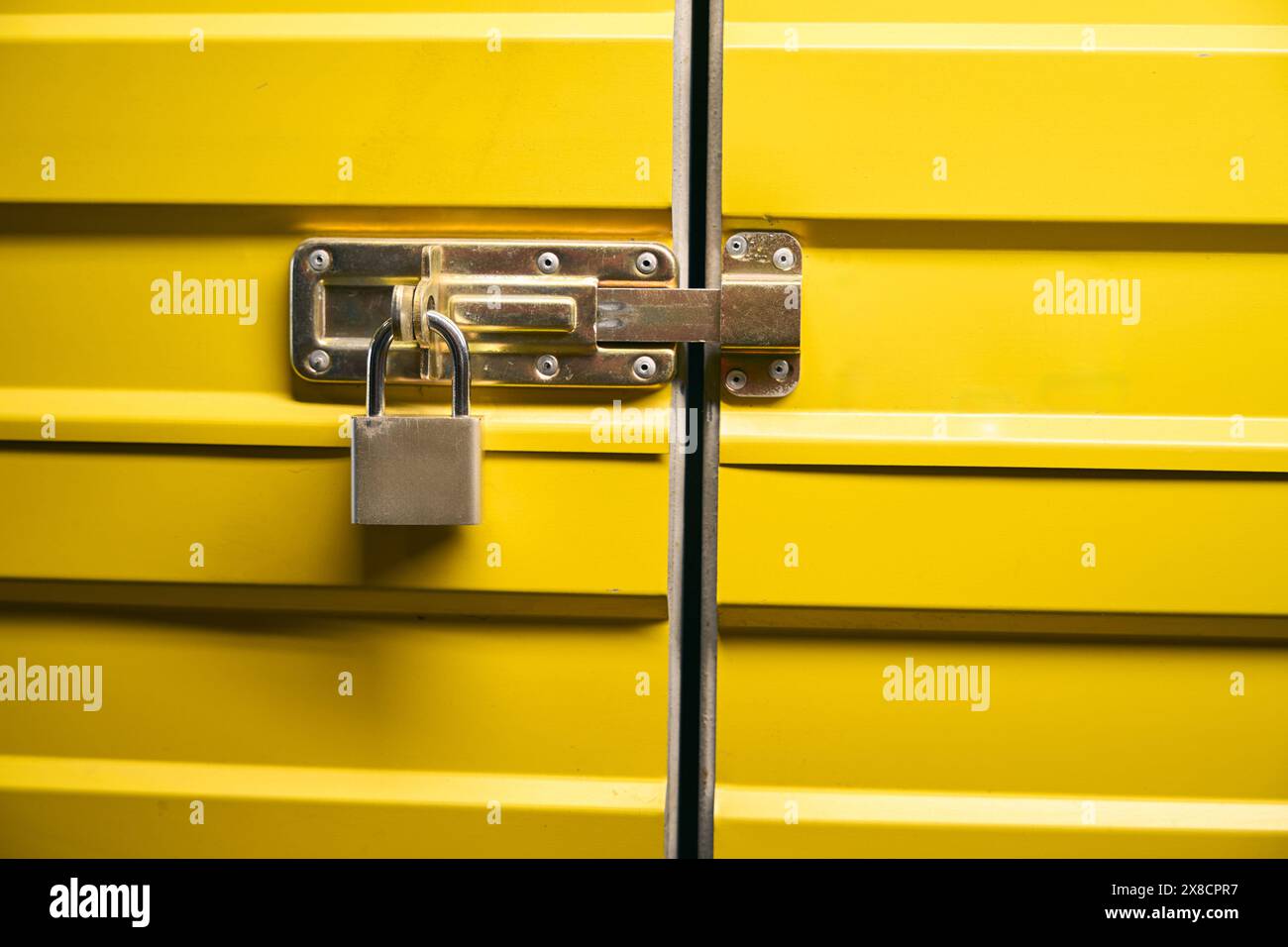 Steel secure lock on storage unit door Stock Photo - Alamy