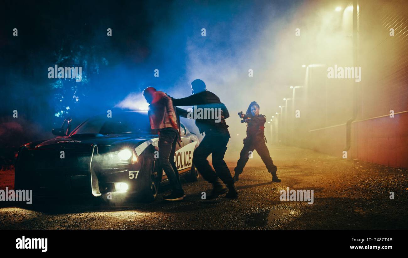 Male Policeman Forcing a Compliant Civilian on the Hood of Police Car ...