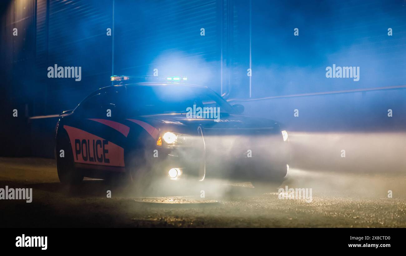 Police Officers in Patrol Car Driving through Dark Streets of a City ...