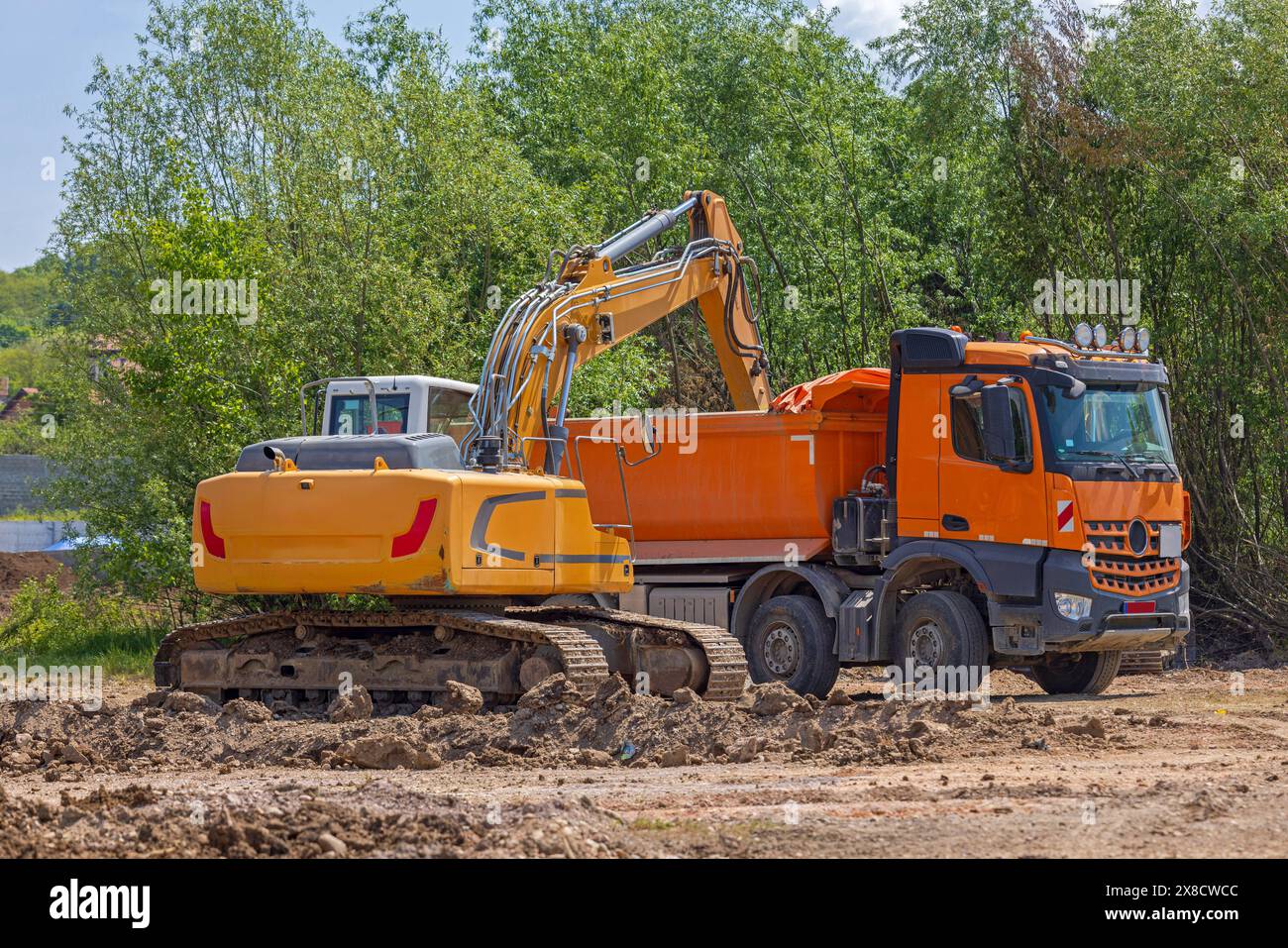 Tipper Truck Loading With Dirt With Excavator Machinery at Construction ...