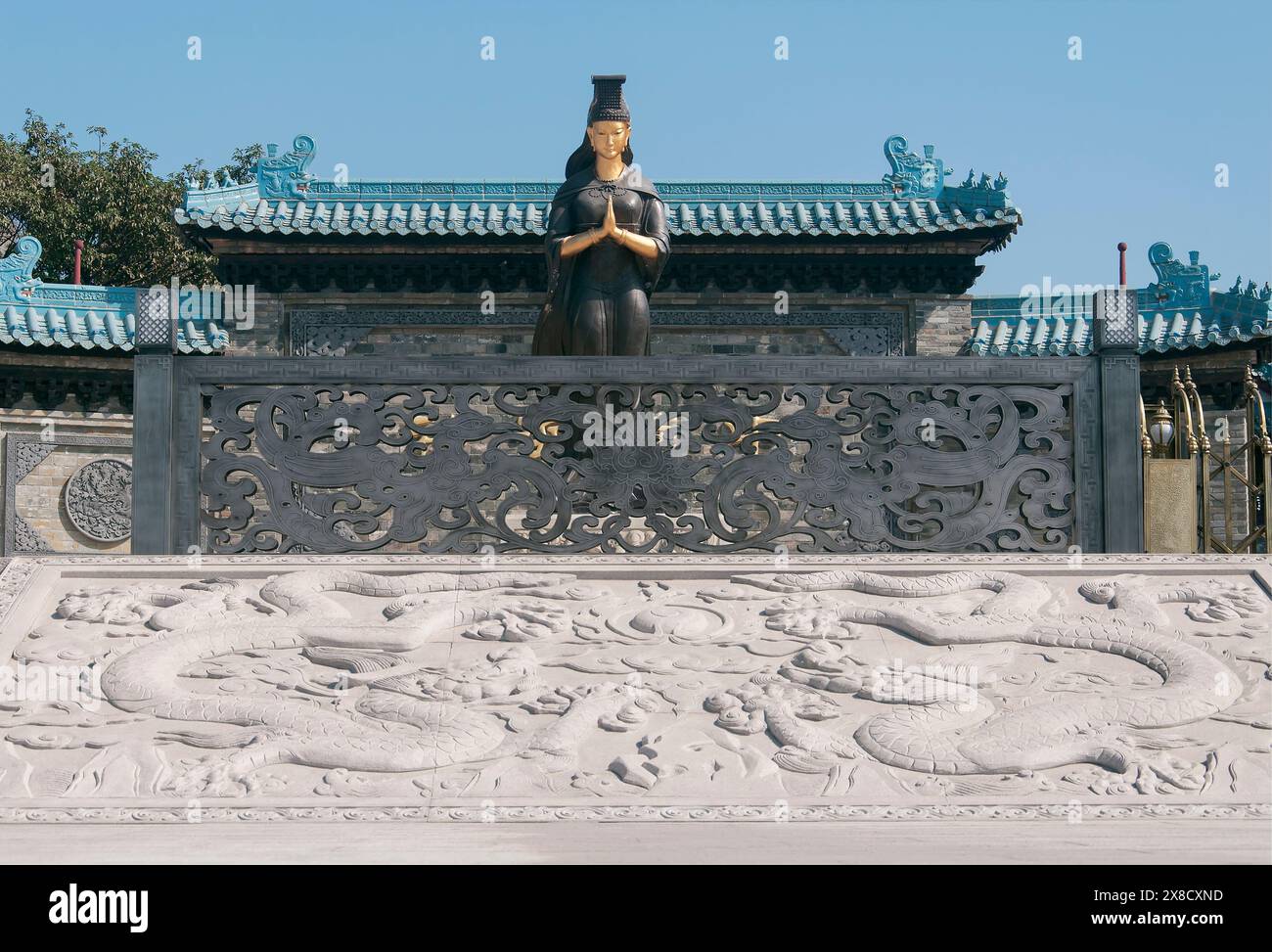 A large stone mural in front of the goddess of the sea, Tian Hou, at ...