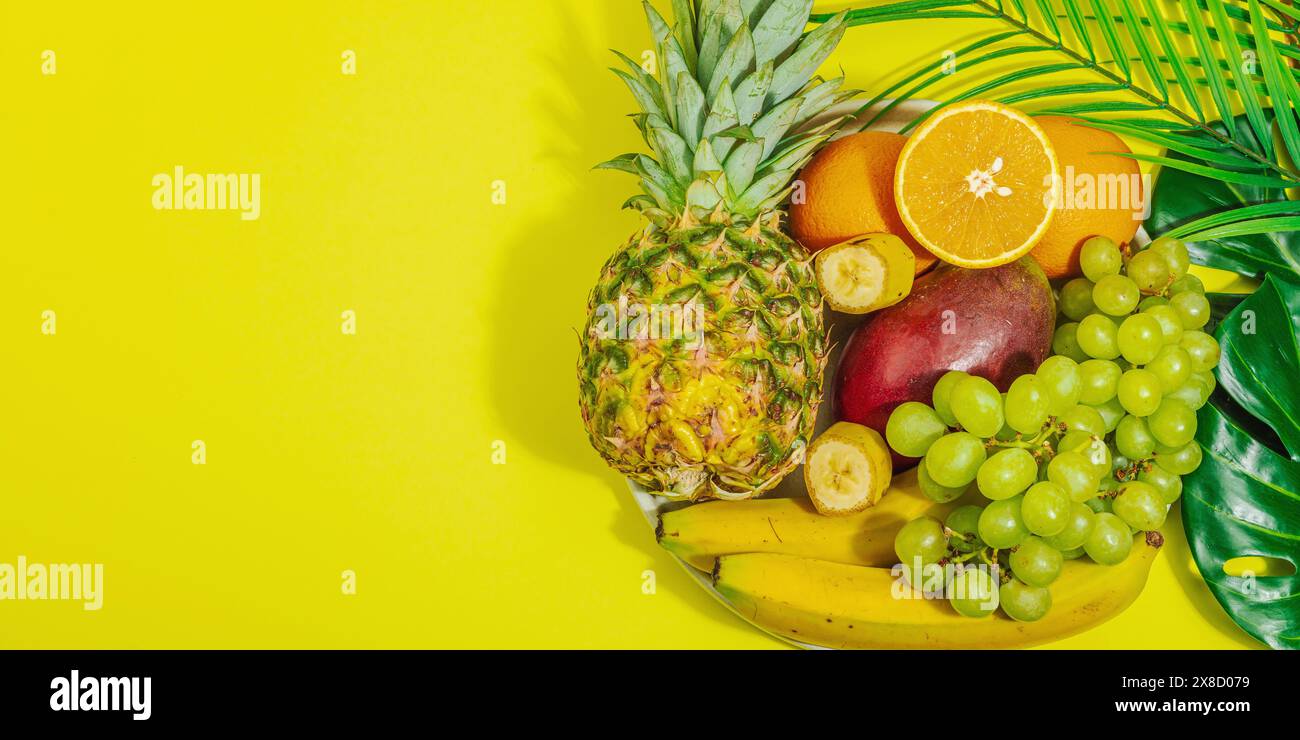 Set of fresh tropical fruits. Ripe mangoes, pineapple, oranges, grapes ...