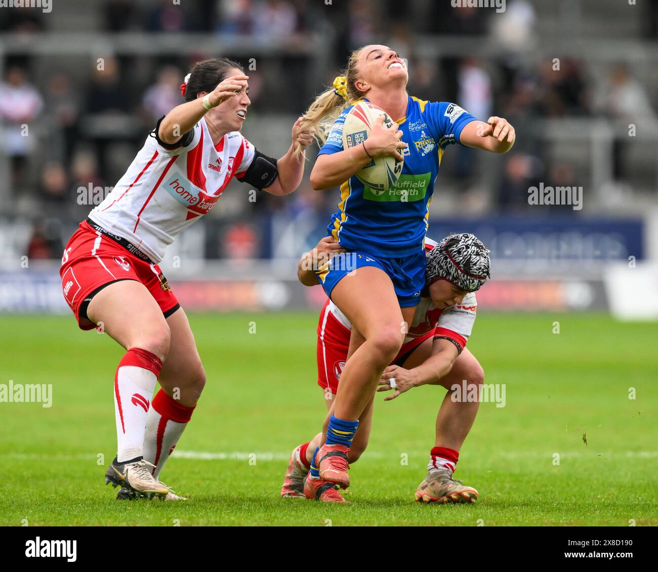 Lucy Murray of Leeds Rhinos has her hair pulled by Faye Gaskin of St ...