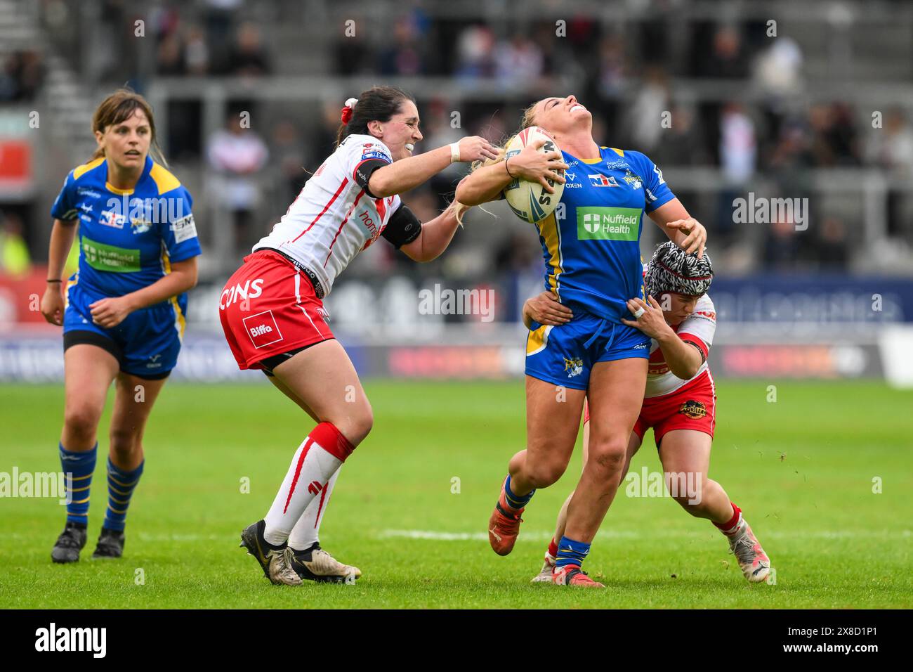 Lucy Murray of Leeds Rhinos is tackled by Faye Gaskin of St Helens ...