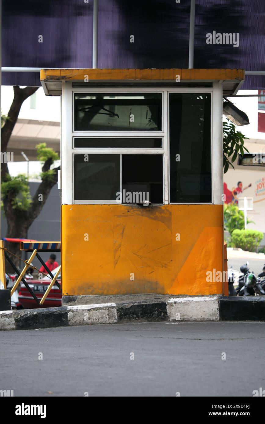 Yellow and White ticket booth on Roadside. A yellow and white ticket ...