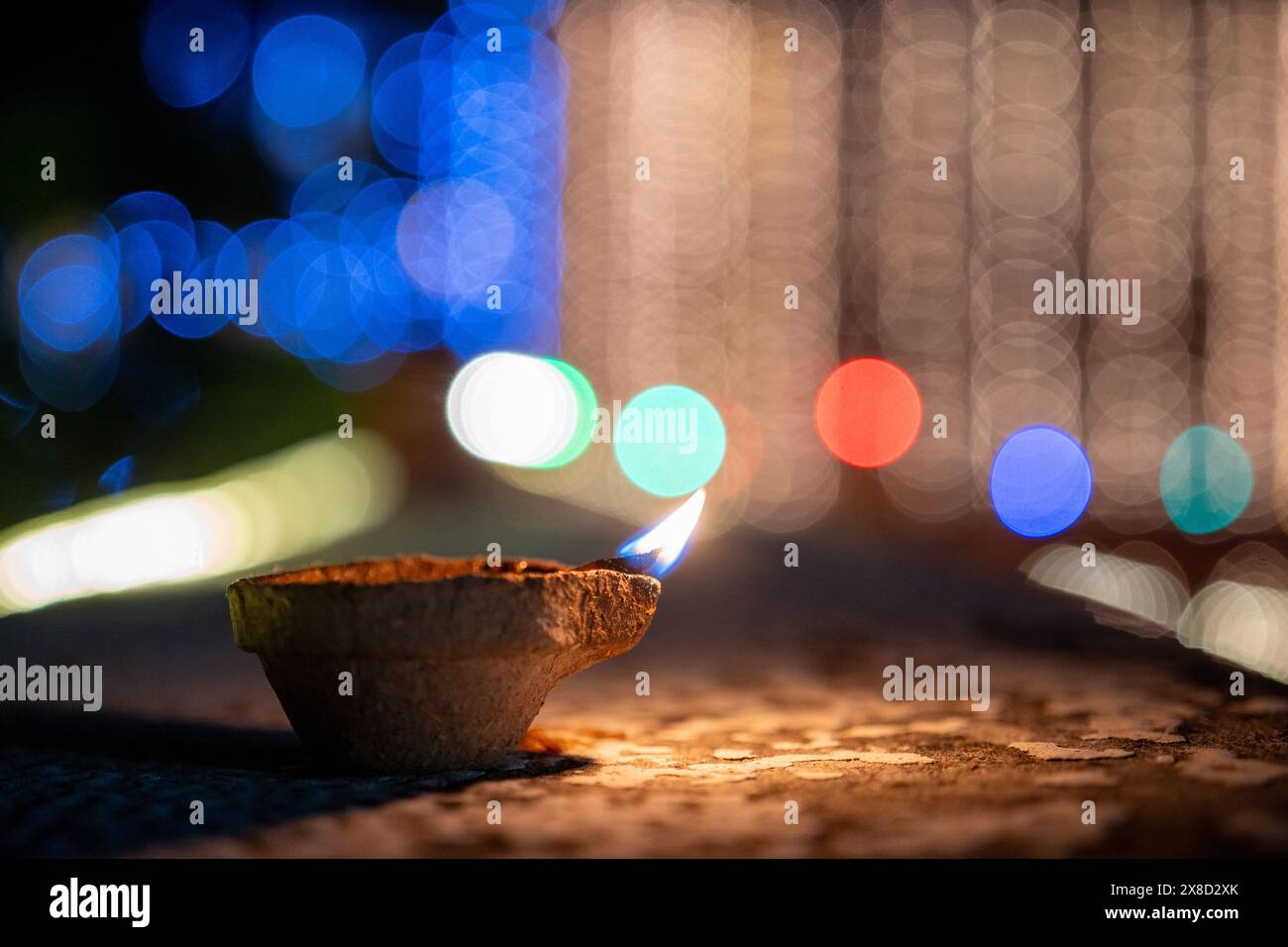 handmade earthenware clay coconut fiber diya lamp lit in front of the ...