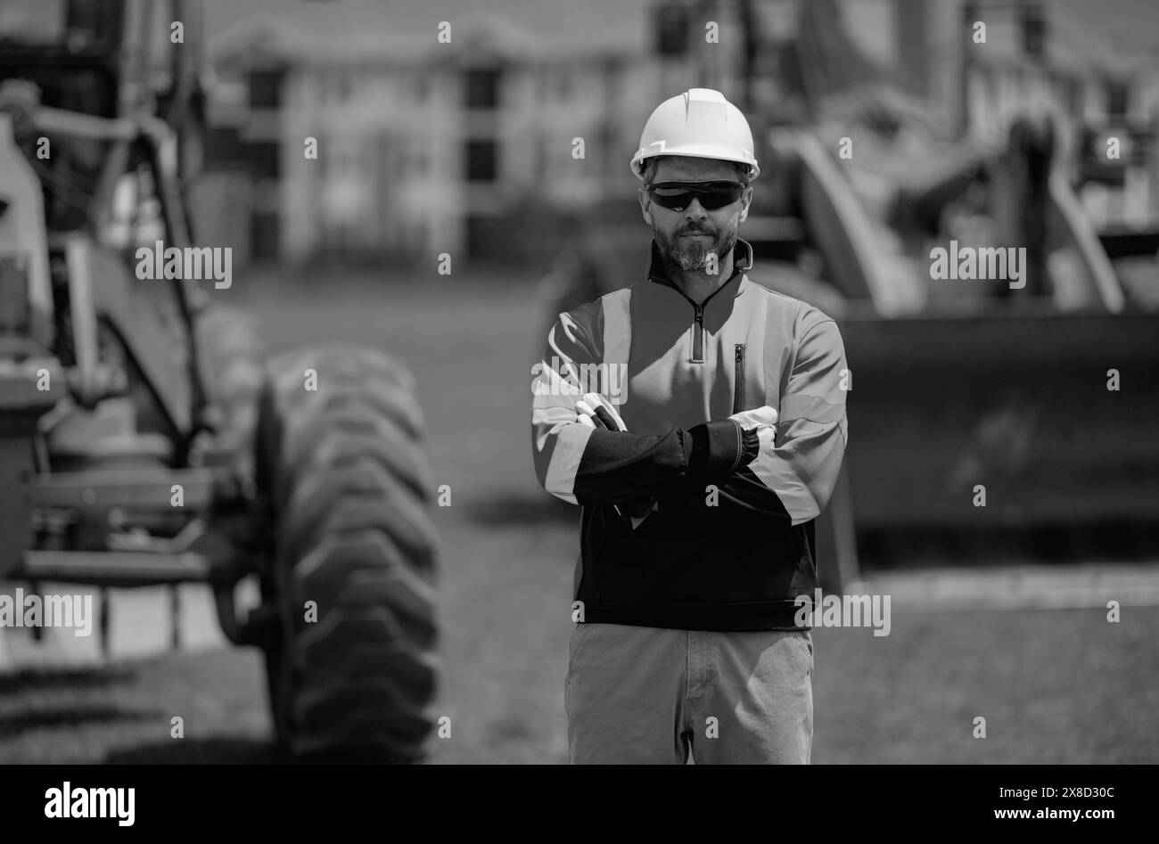 Portrait of builder in a construction site. Builder with excavator ...