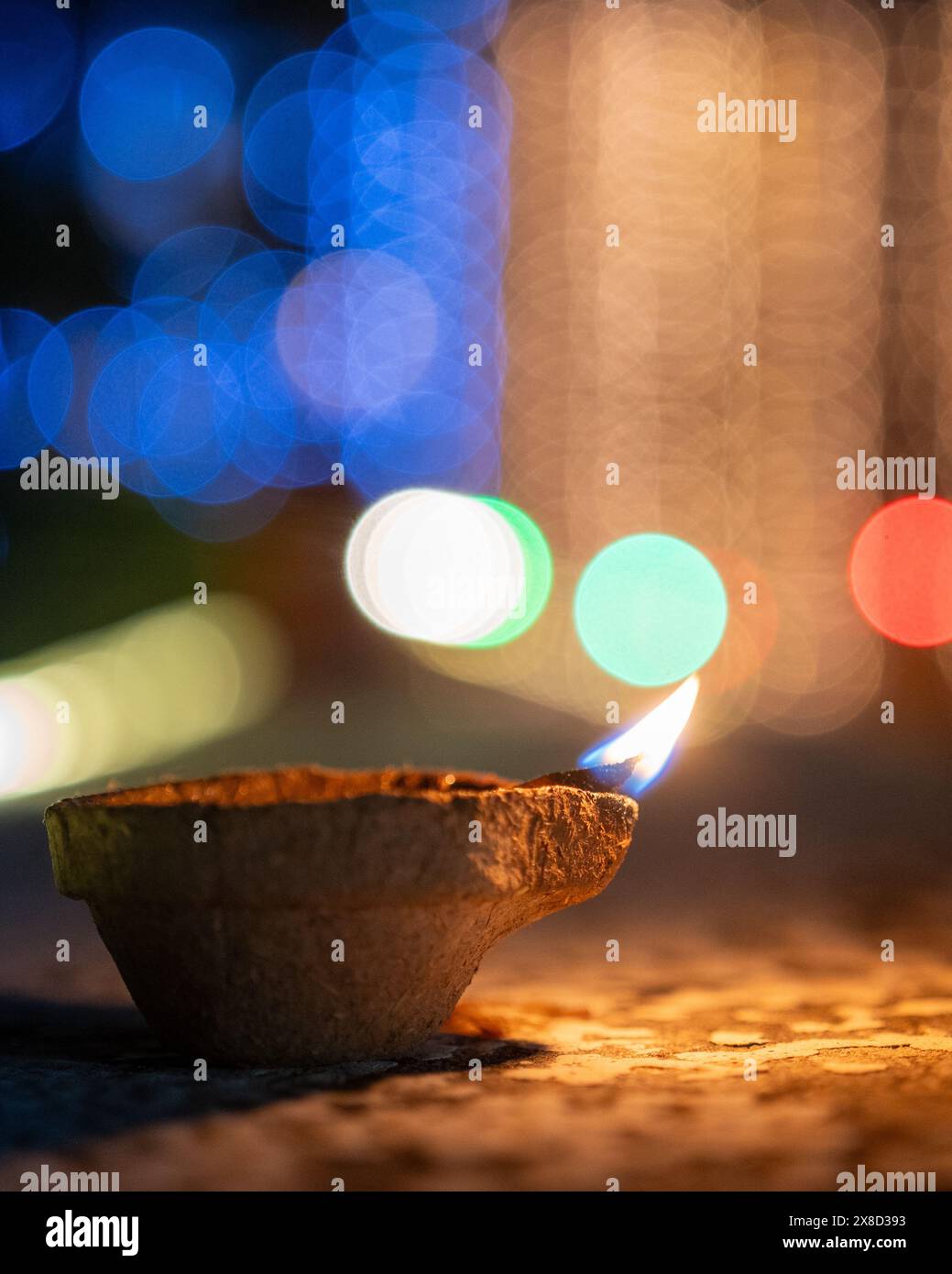 handmade earthenware clay coconut fiber diya lamp lit in front of the ...