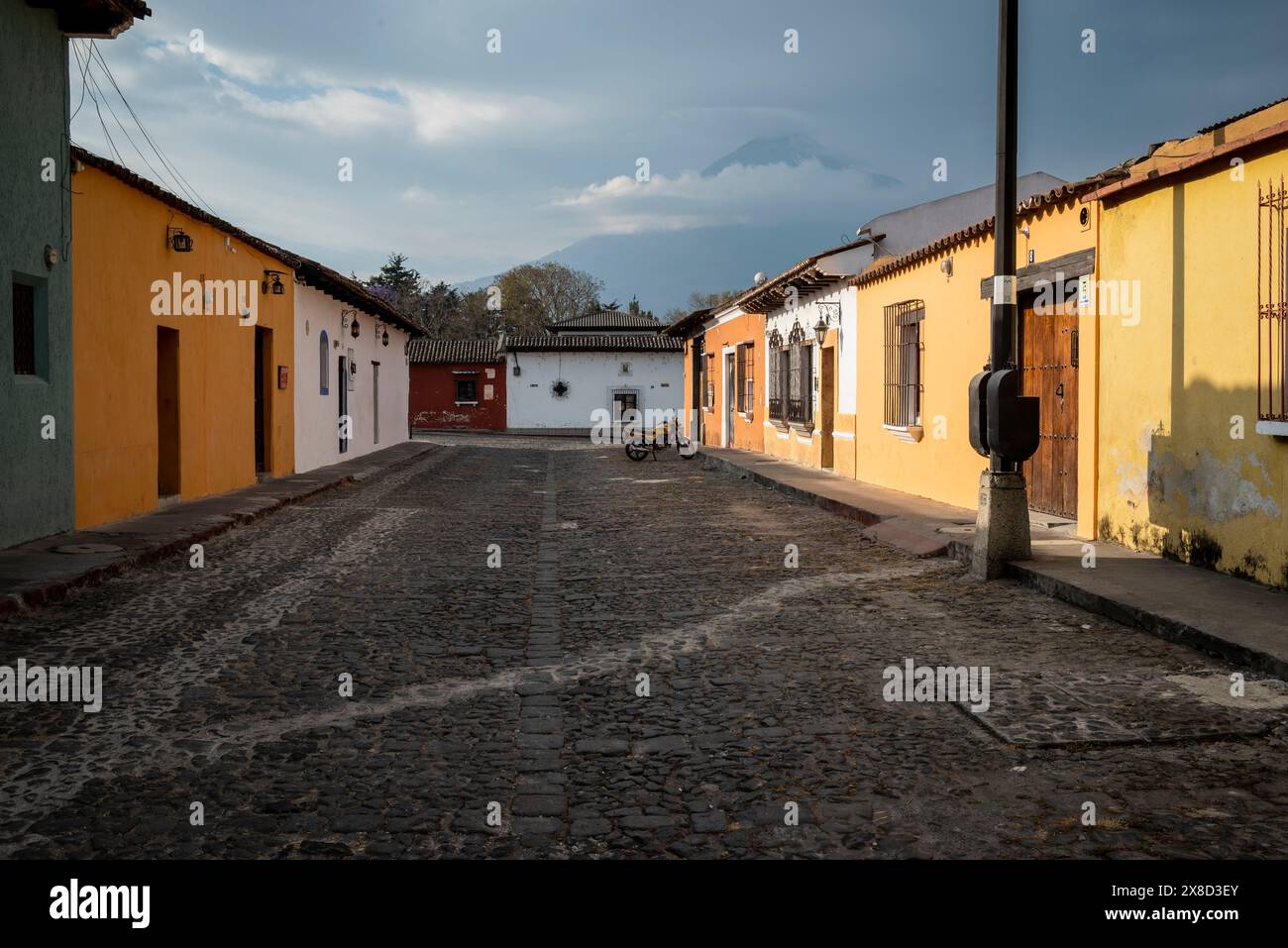 Cobblestone street and Spanish colonial-style architecture with Water ...