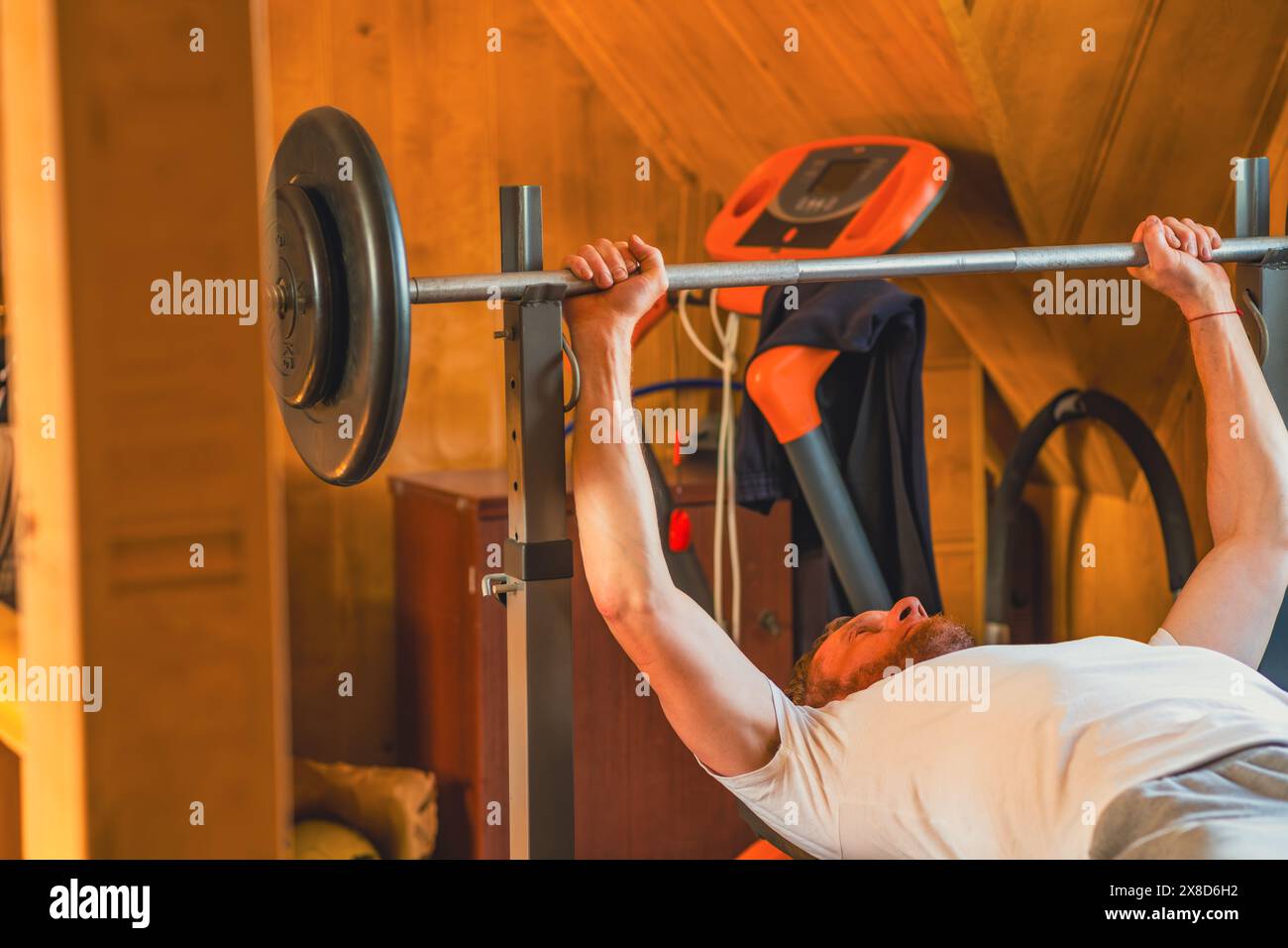 A man doing a bench press with a barbell in the gym Stock Photo - Alamy