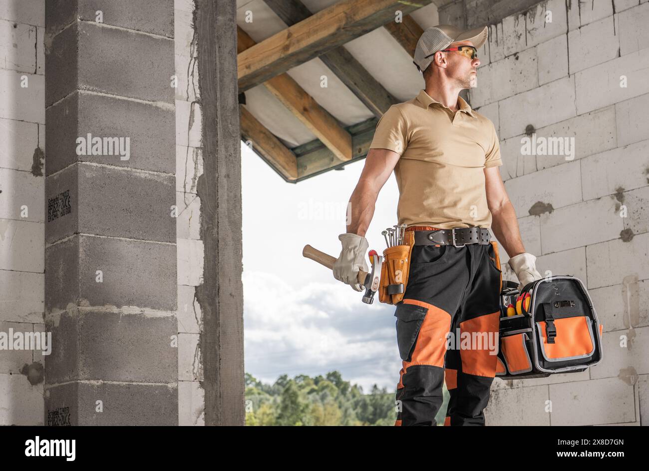 Construction contractor worker standing and holding a tool bag in one ...