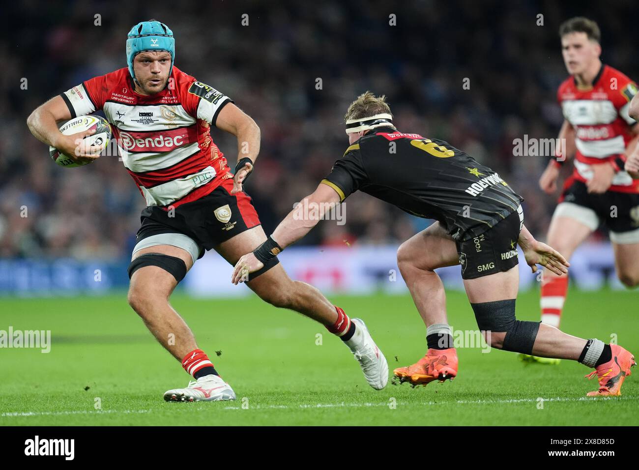 Gloucester Rugby's Zach Mercer (left) is tackled by Hollywoodbet Sharks ...