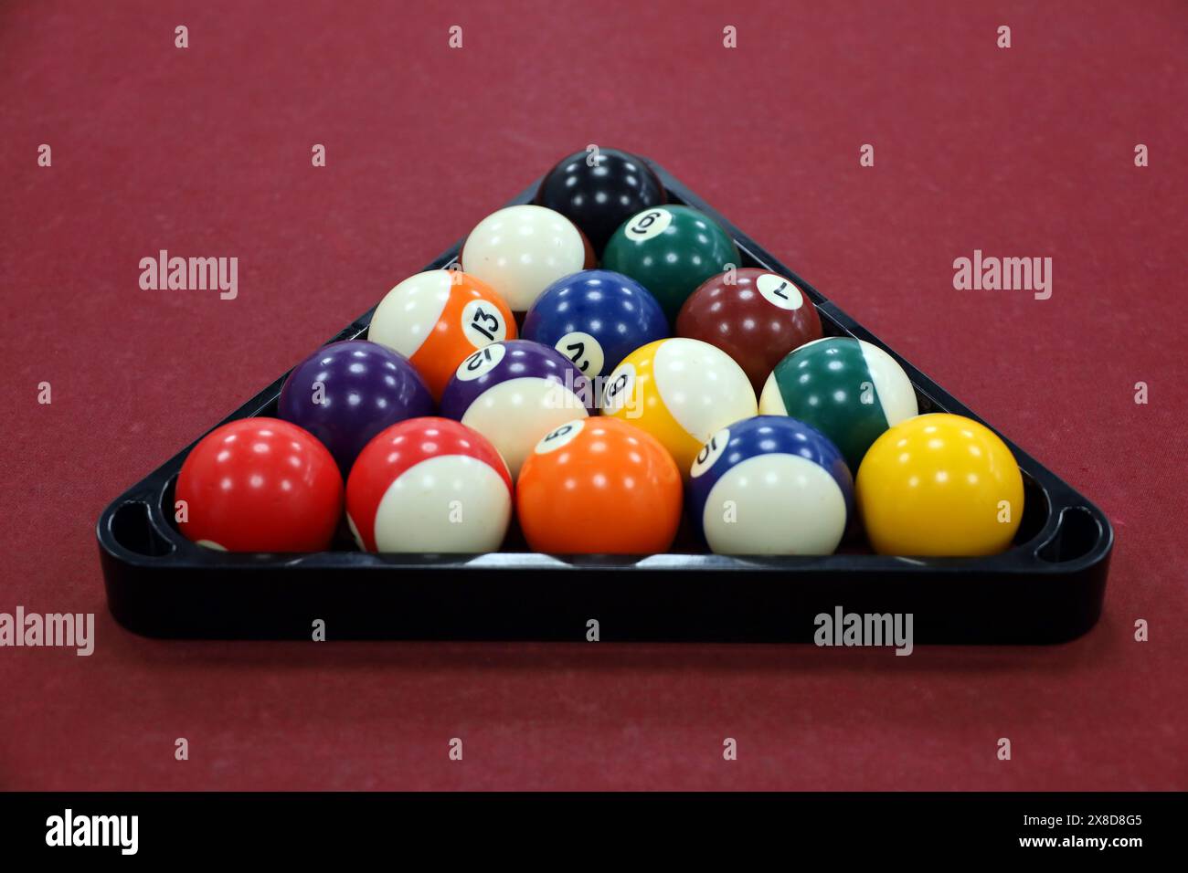 Set of billiard balls in a triangle on a red table Stock Photo - Alamy