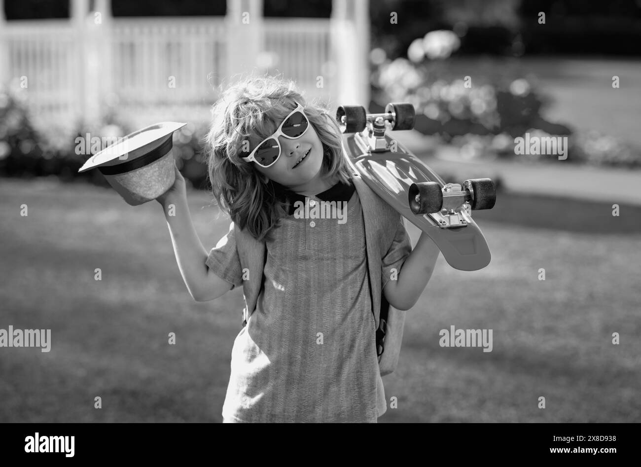 Child boy holding longboard on pink background. Kid with pennyboard ...