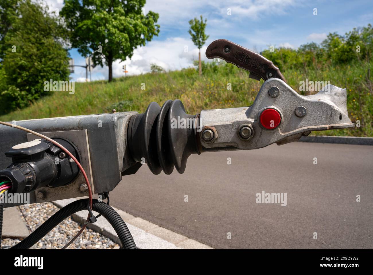 Trailer tow bar close up. Scene at the side of a street, on a parking ...