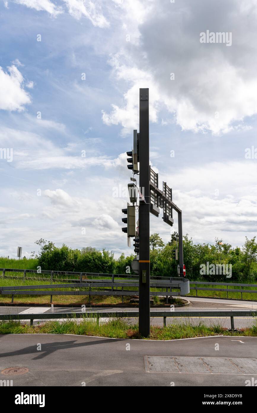 Sign gantry and mast with traffic light and signs on the junction of ...