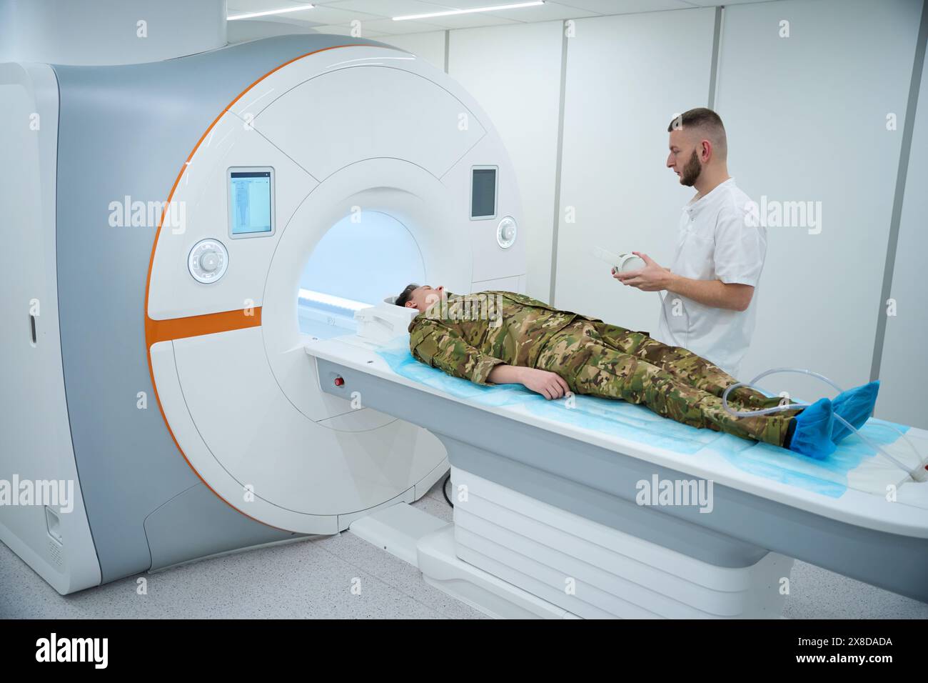 Radiographer preparing military patient for magnetic resonance imaging ...