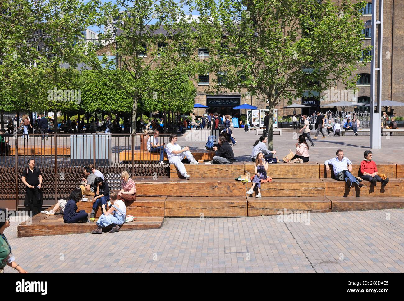 Late spring sunshine on Granary Square at Kings Cross, in north London ...