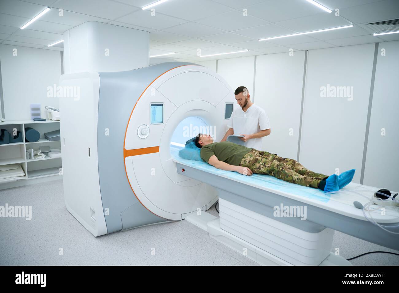 Technologist preparing military patient for upper extremity joint MRI ... Technologist preparing military patient for upper extremity joint MRI ...