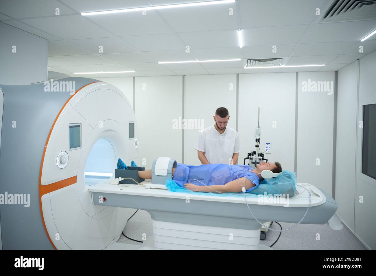 Healthcare professional preparing patient for lower extremity MRI Stock ...