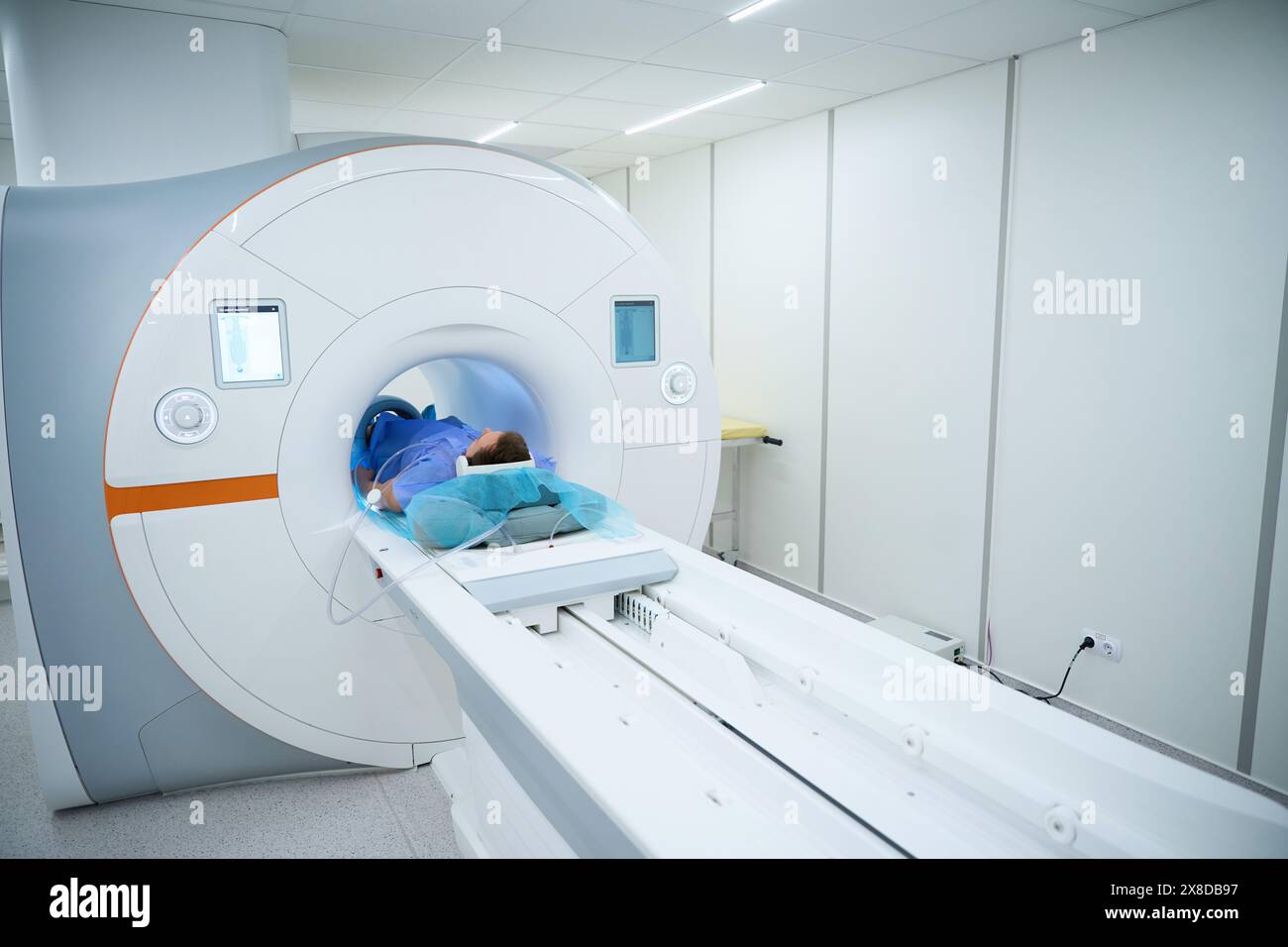 Adult person undergoing magnetic resonance imaging of lower extremity ...