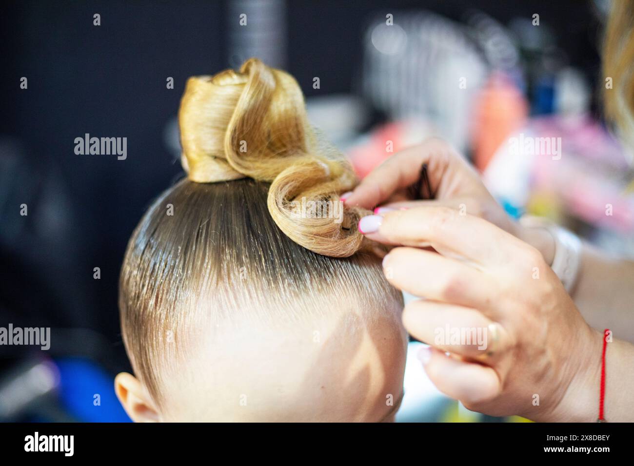 stylist to create a fashionable ponytail hairstyle for a ballroom ...