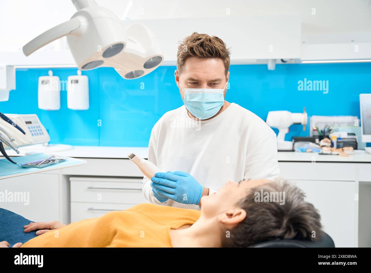 Man dentist using intraoral scanner to capture detailed images of ...