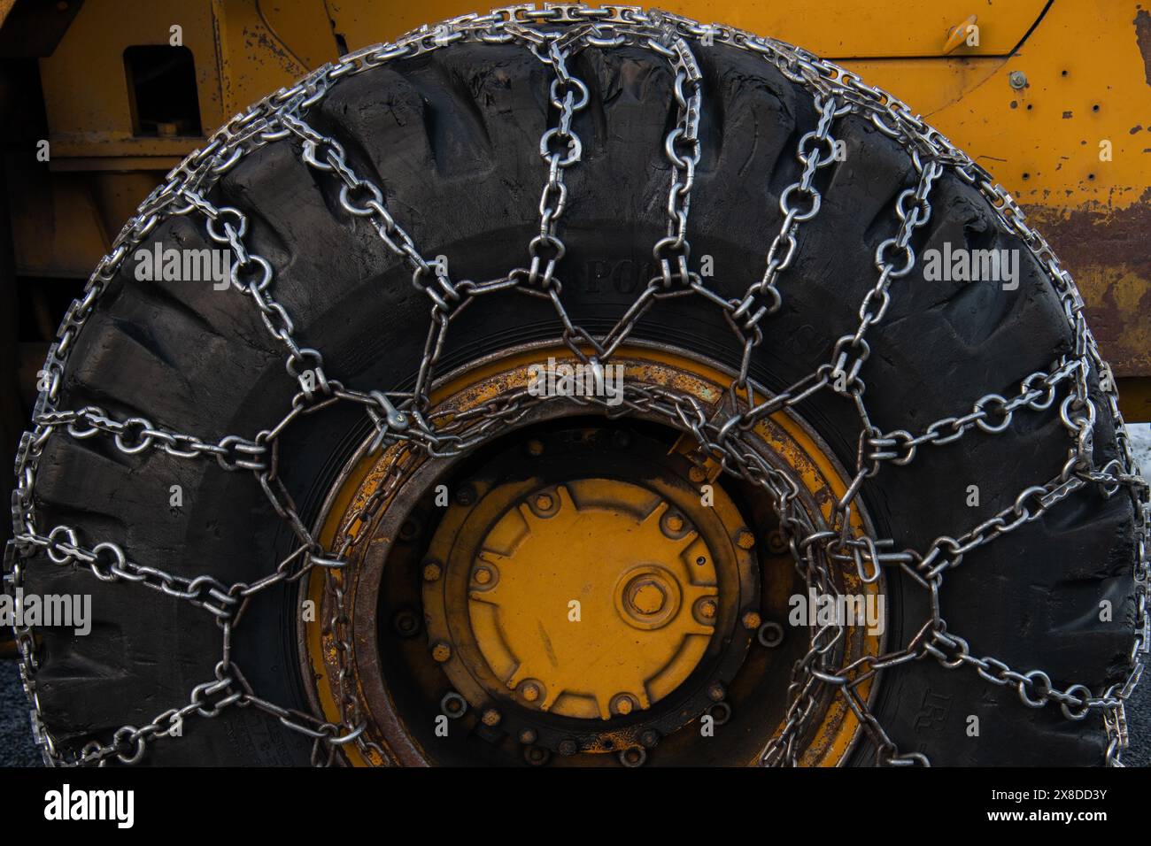 Snow chains on the wheel of a snow plow in the California mountains ...