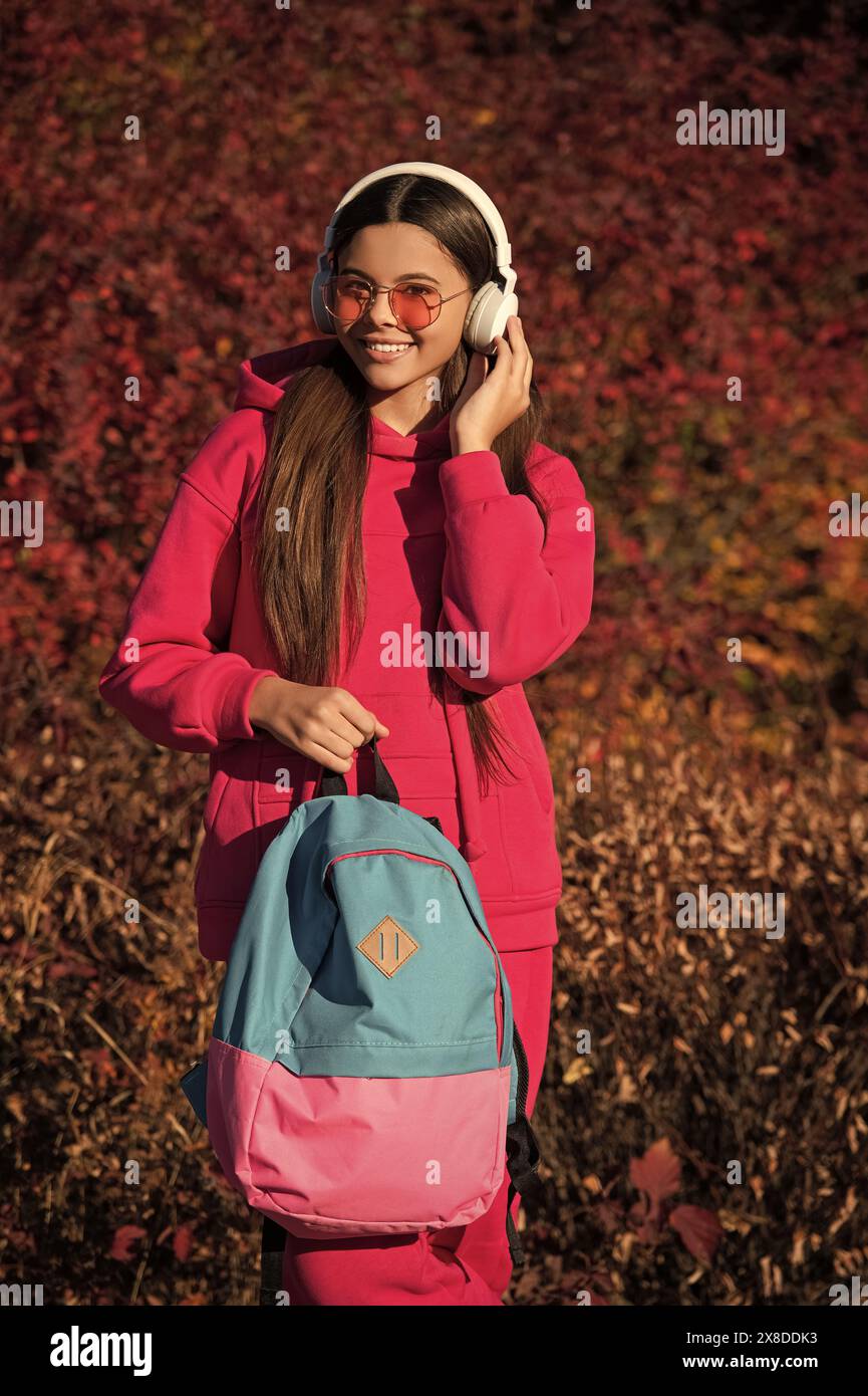 gen z. girl in autumn park with backpack. autumn school girl ready to ...