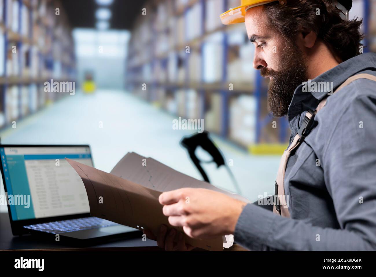 Industrial worker reading shipment invoice details in warehouse ...