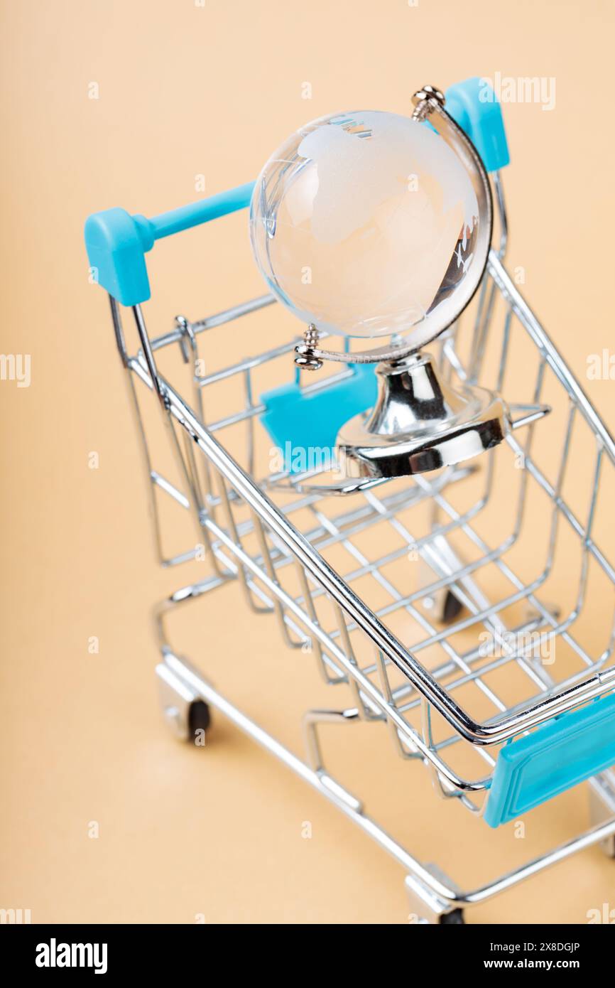 Shopping Cart Containing Glass Globe on Beige Background, World Trade ...