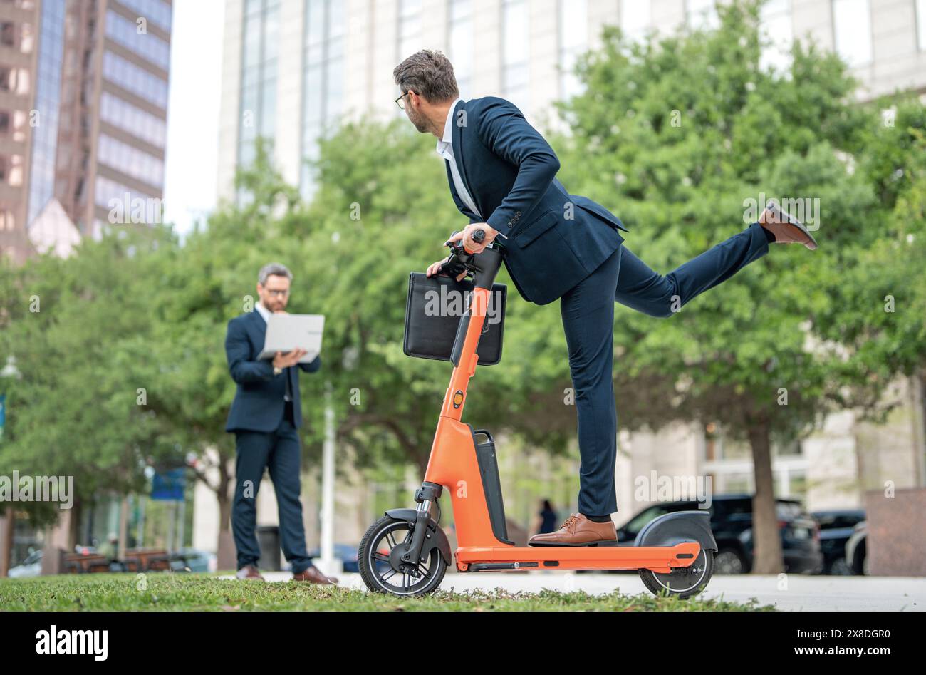 Ecological transportation concept. Business man in suit riding an ...