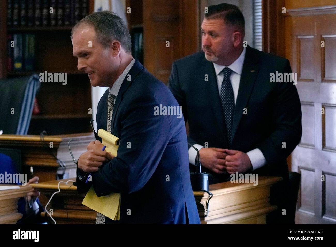 Witness Brian Higgins, right, follows his attorney William Connolly out ...
