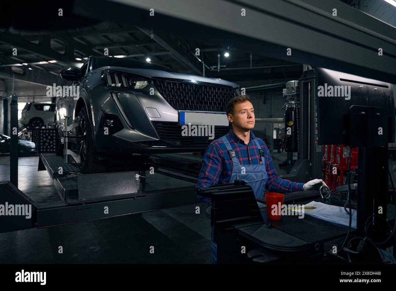 Worker working with instrument for wheel repair Stock Photo - Alamy