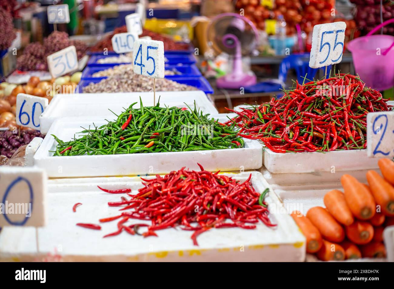 Asian vegetable market. Piles of hot chili peppers and other vegetables ...