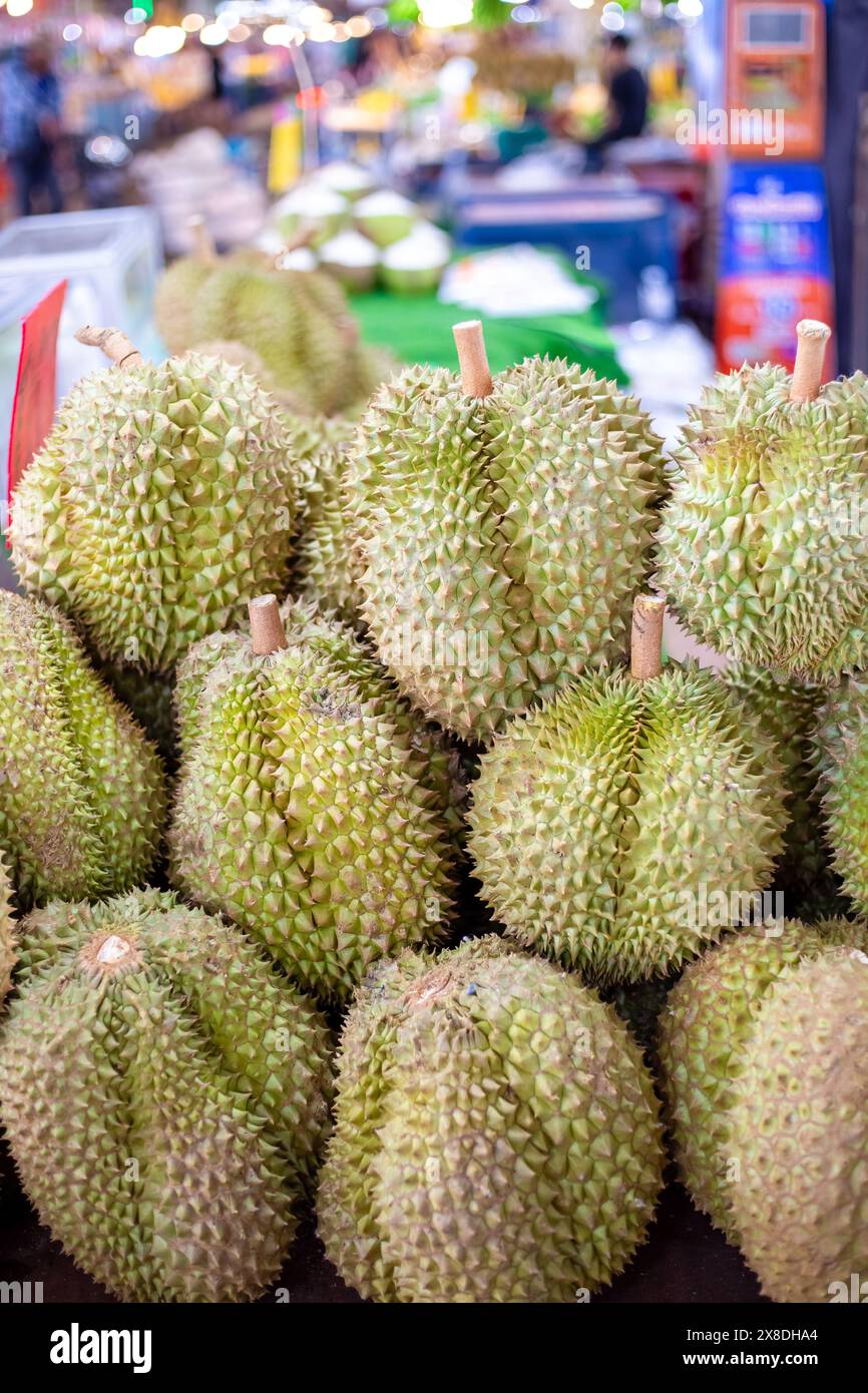 Large spiky durian fruits on a store counter in Asia. Thai fruit market ...