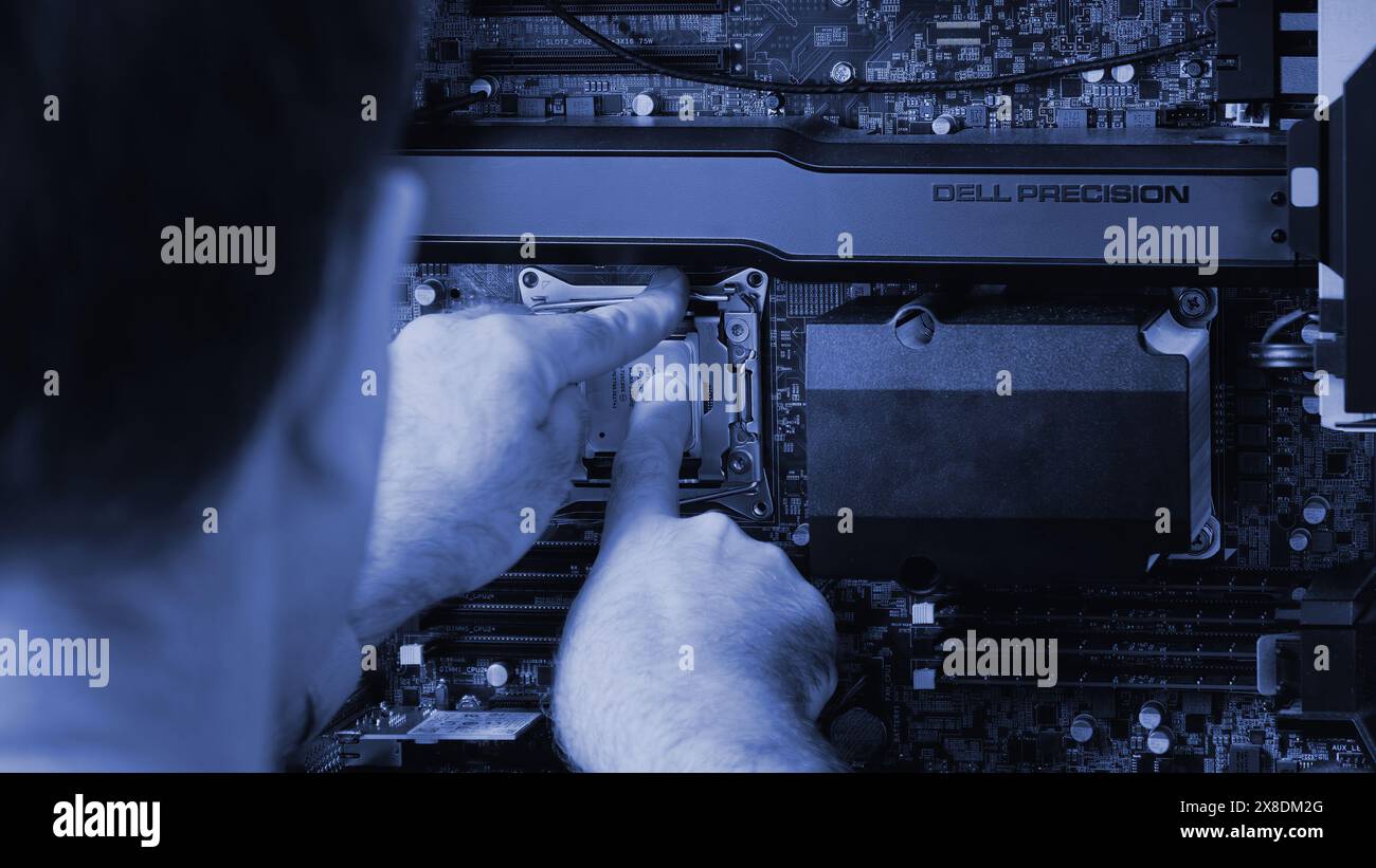 London, UK - Aug 27, 2022: A close-up view shows a technician securing ...