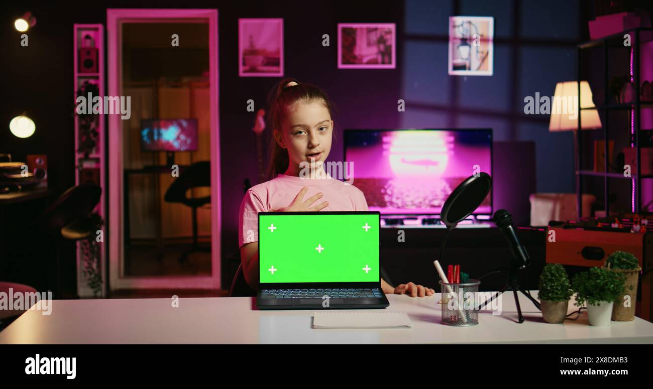 Young girl tech content creator filming technology review of green ...