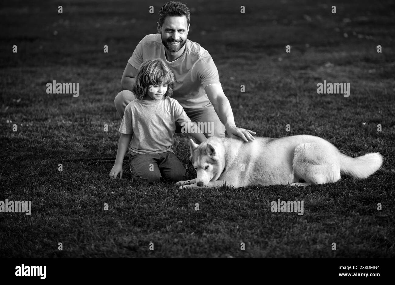 Father and son with dog on nature. Dad and child with pet dog having ...