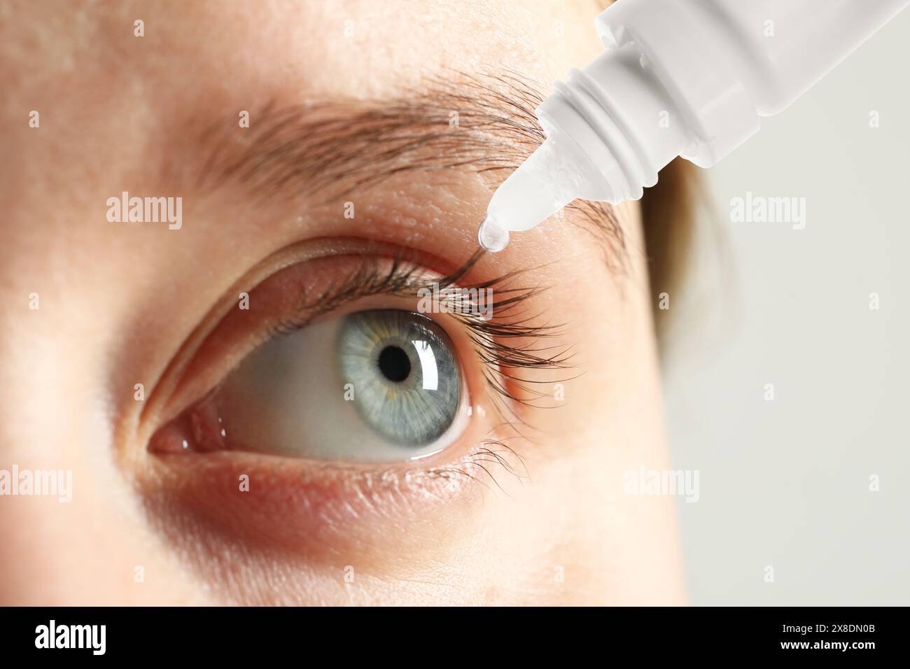Woman applying natural drops hi-res stock photography and images - Alamy