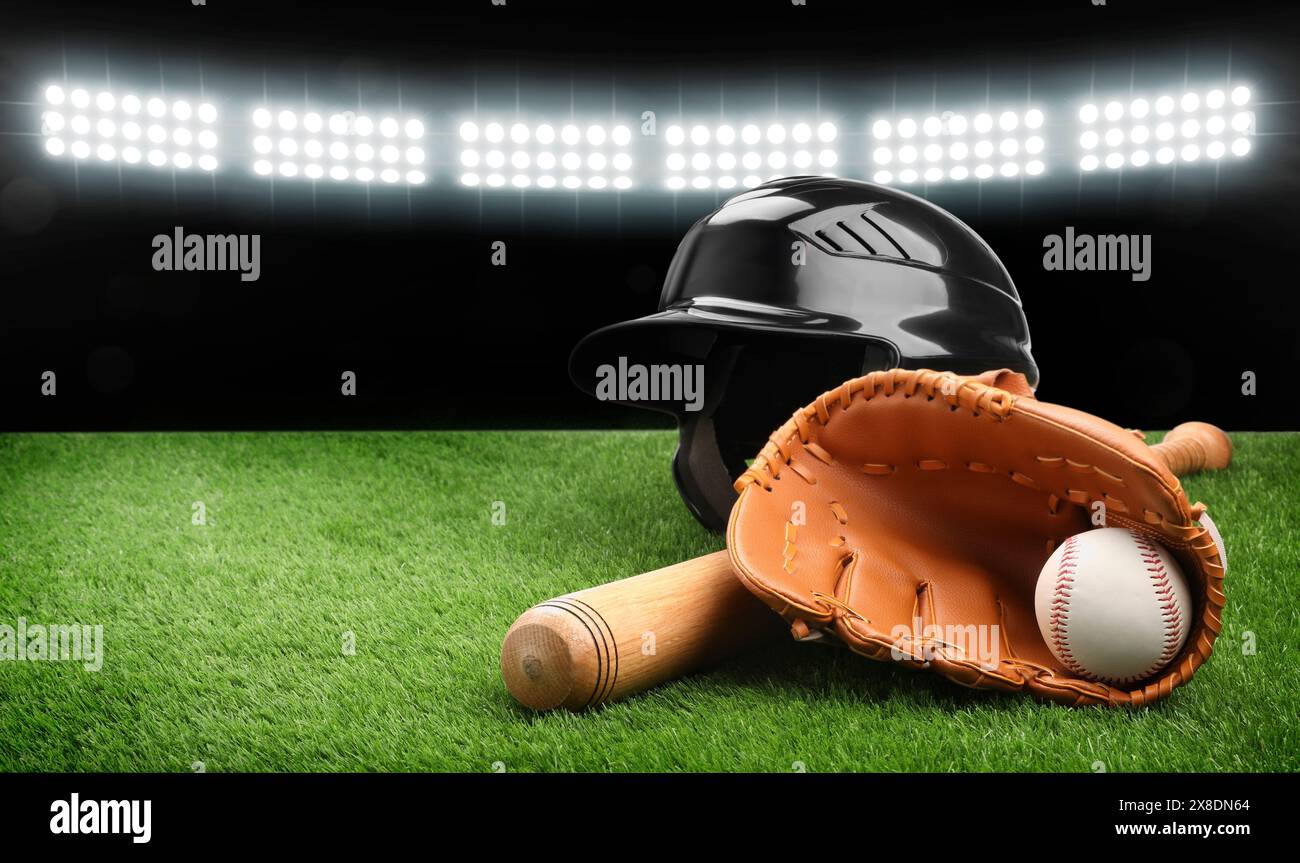 Baseball bat, glove, helmet and ball on grass at stadium. Banner design ...