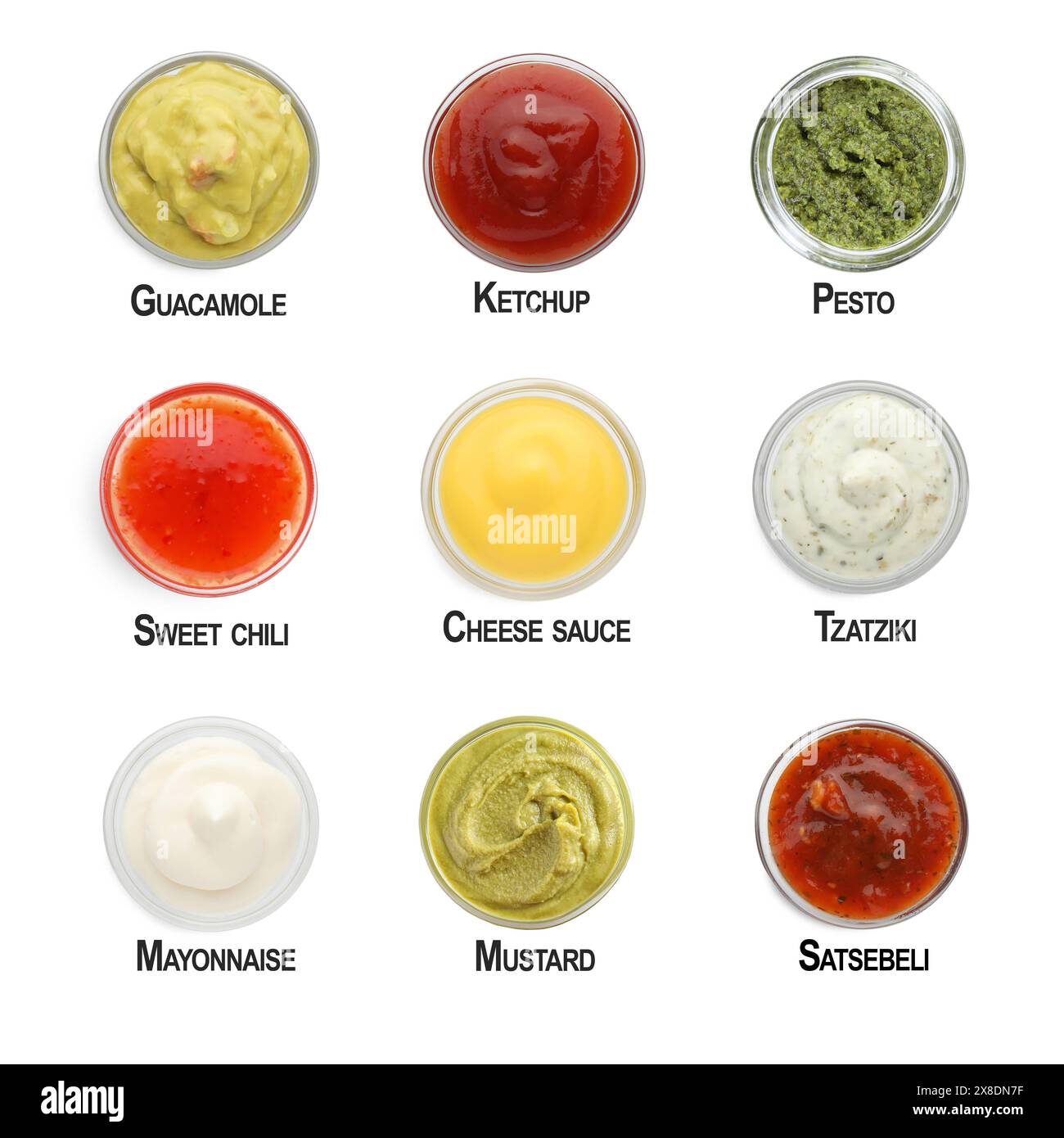 Set of different sauces in bowls and names isolated on white, top view ...